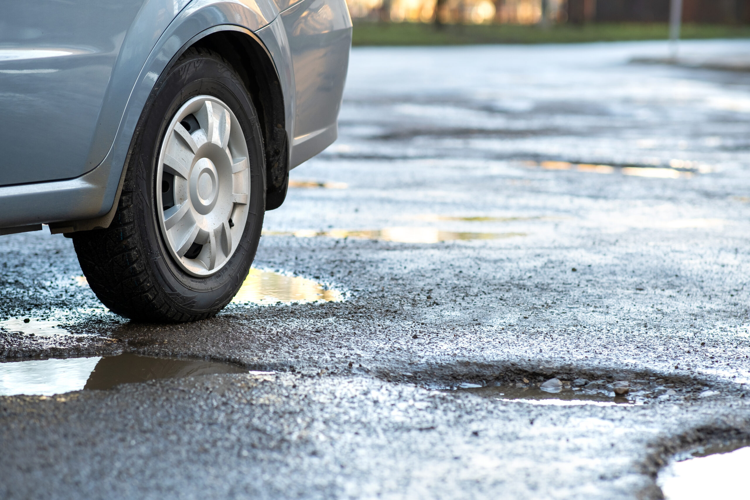 Who is liable when poorly-maintained roads cause a car accident?